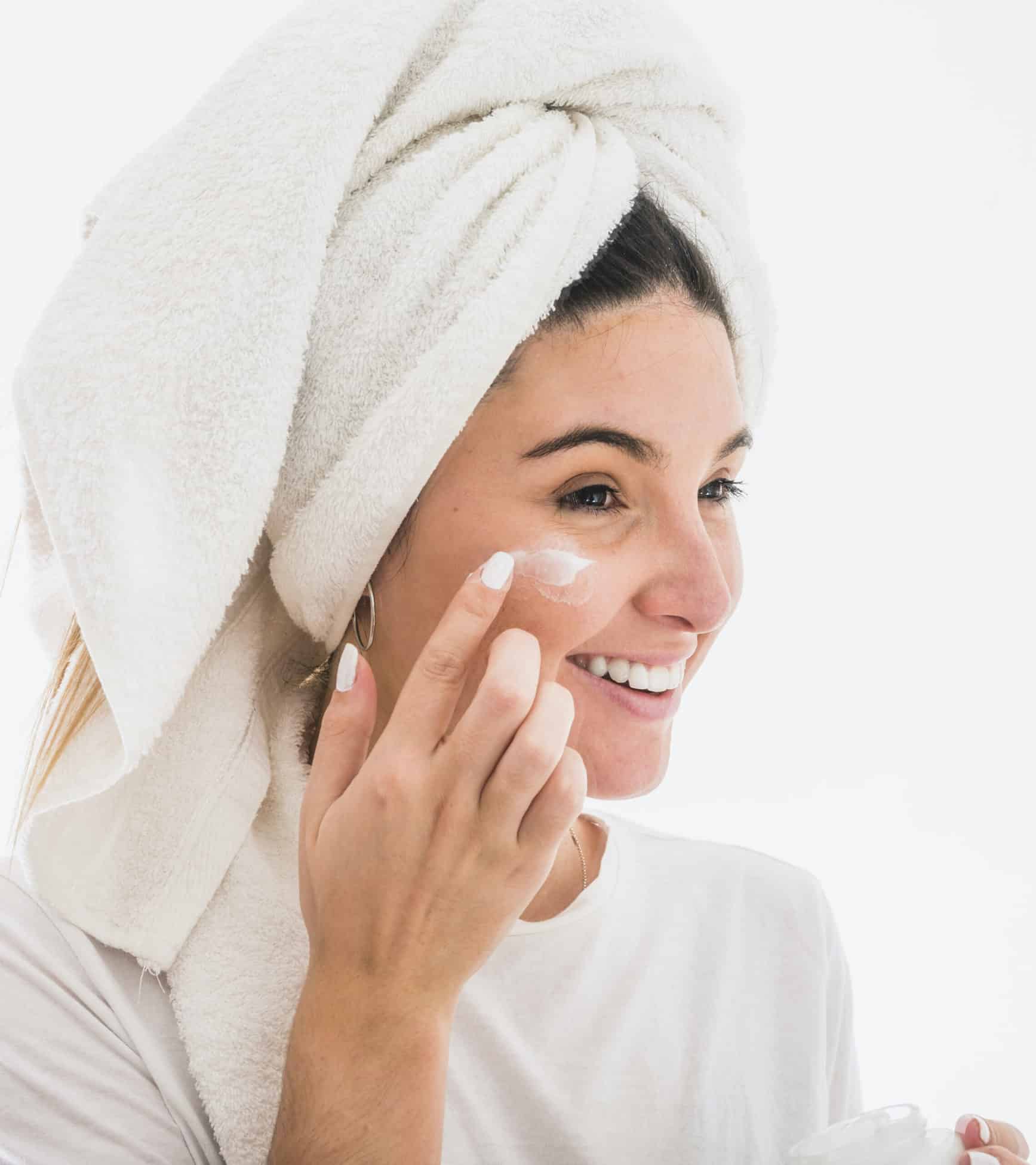happy-portrait-young-woman-applying-cream-her-face - An Unblurred Lady